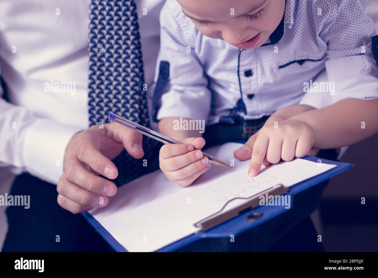 Dad helping son write hi-res stock photography and images - Alamy