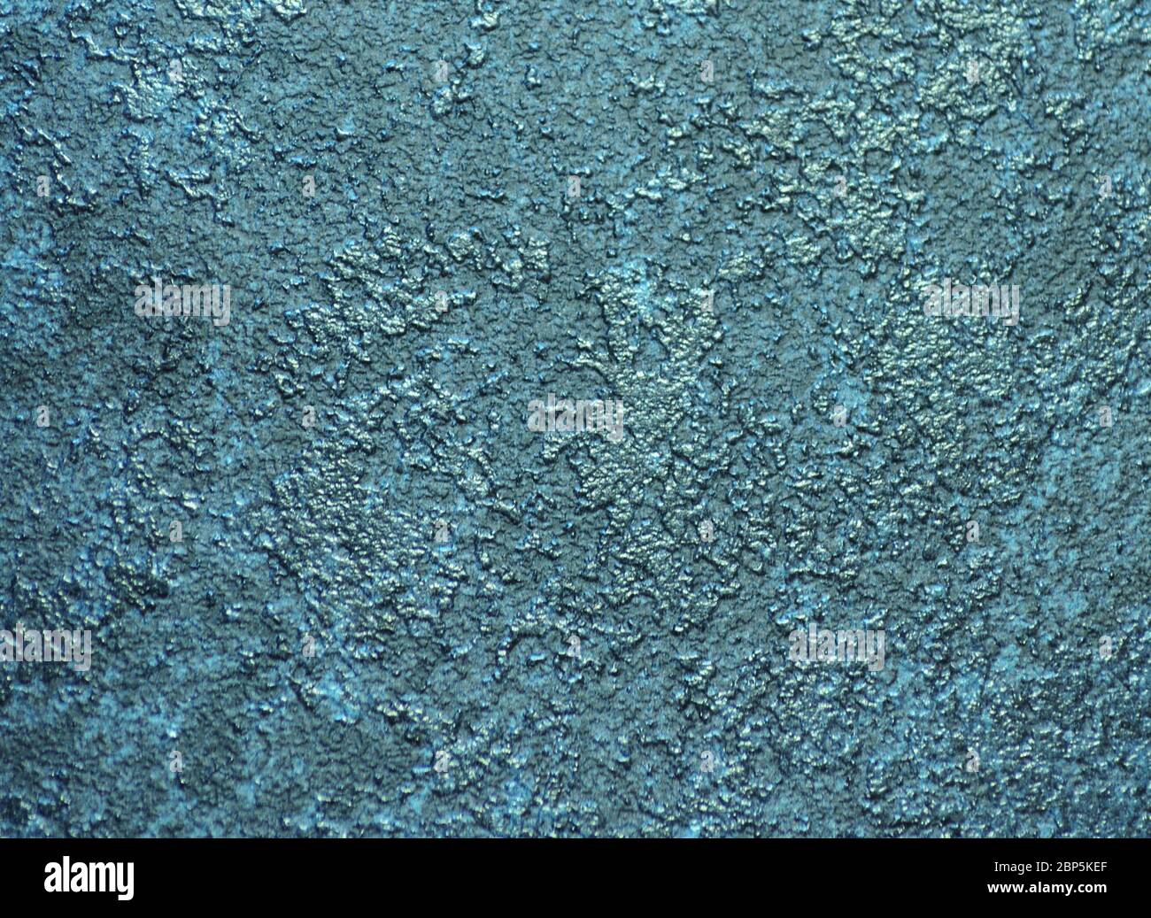 Rough and rough surface of natural stone painted in turquoise blue ...