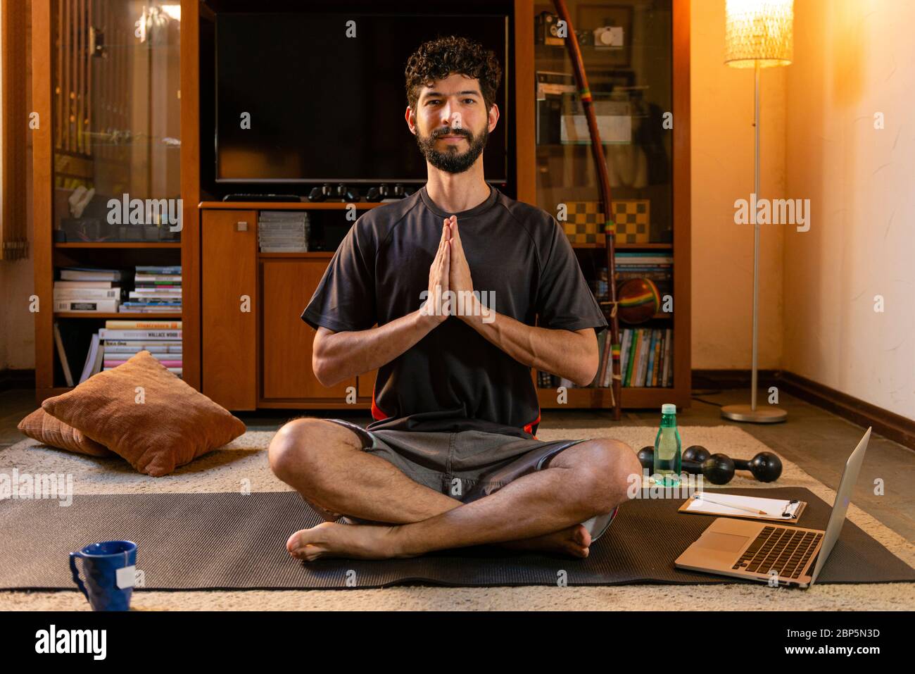 Man performing meditation at his residence. Yoga practice through ...
