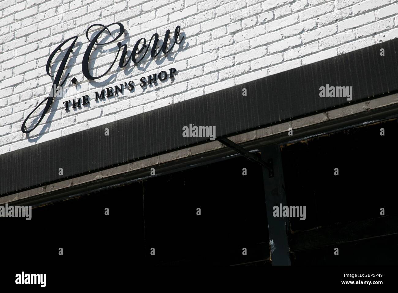 A logo sign outside of a J.Crew The Men's Shop retail store location in ...