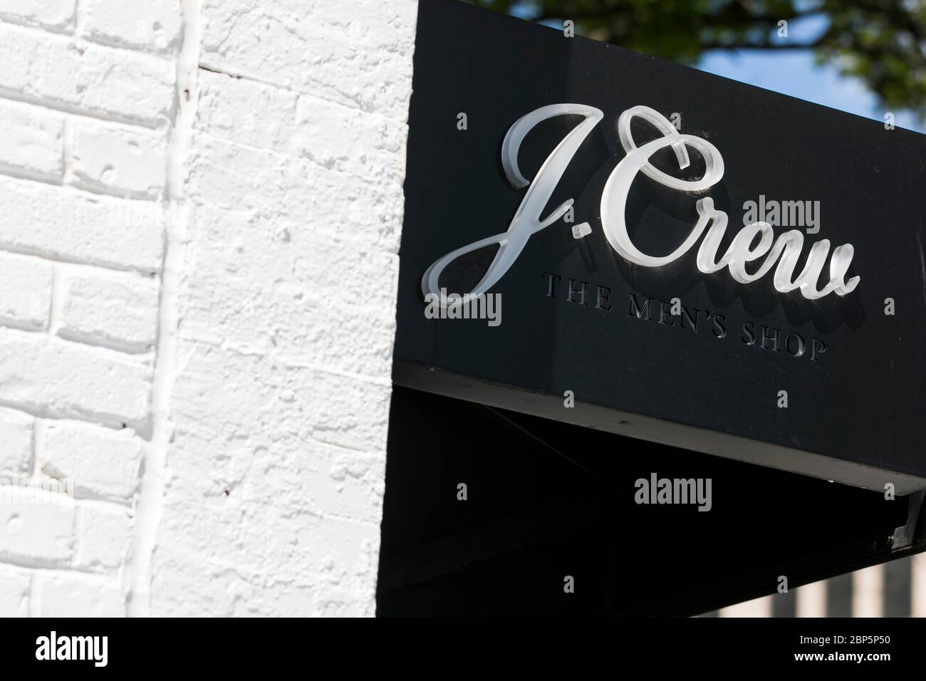 A logo sign outside of a J.Crew The Men's Shop retail store location in ...