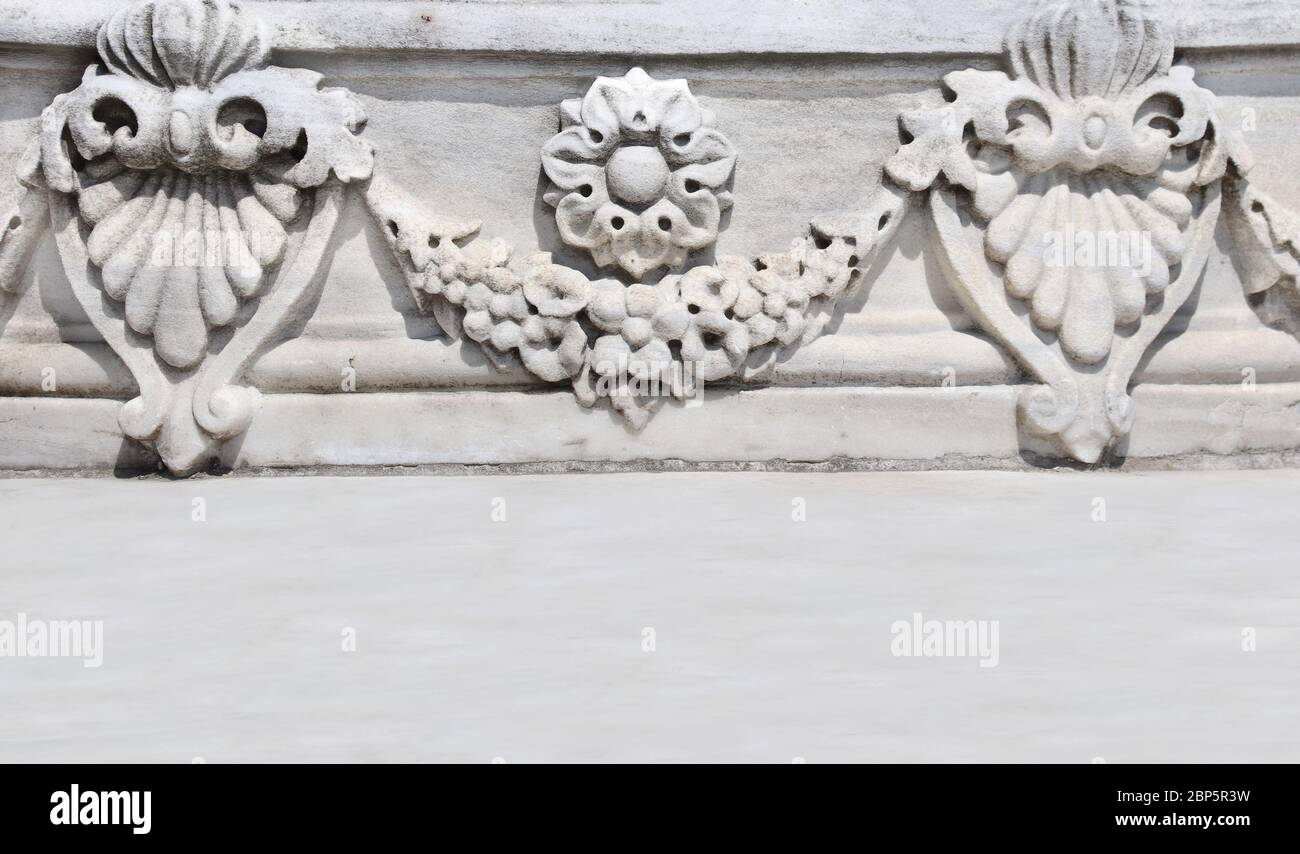 Hprizontal background with ancient carved ornament with flower garland ...