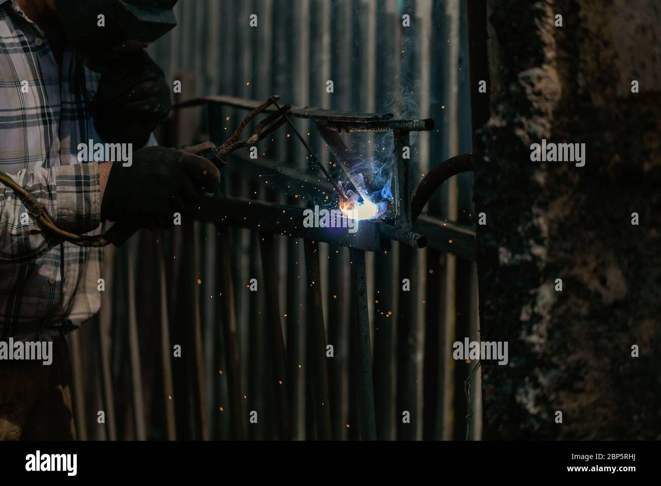 Welding metal structures at a construction site, welding a metal frame ...