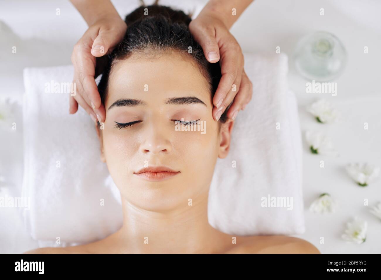 Young woman massaging head oil hi-res stock photography and images - Alamy