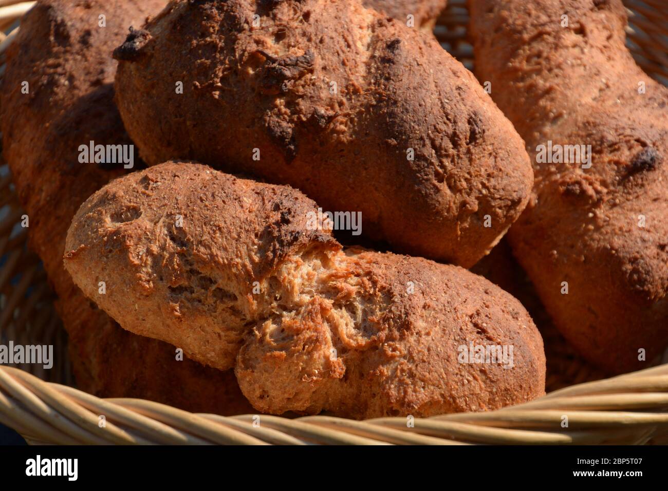 homemade oblong crispy bread rolls made of emmer wheat close-up in ...