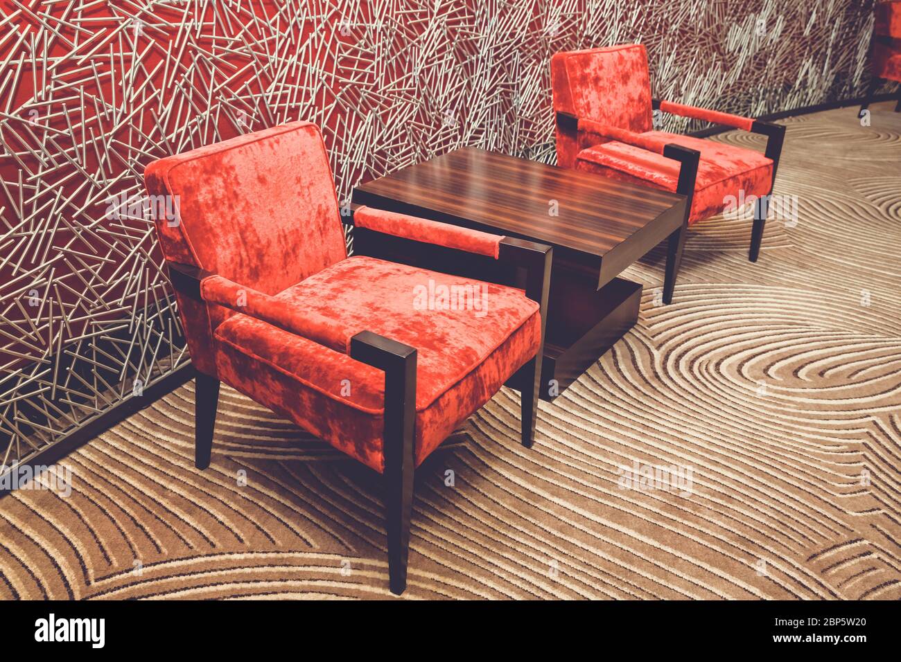armchair in lobby of hotel . Interior of modern hotel . Red leather and ...