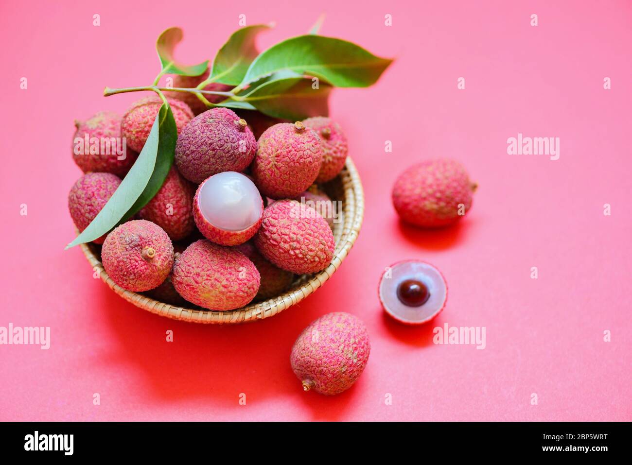 Lychee slice peeled on red pink background / Fresh lychee with green ...