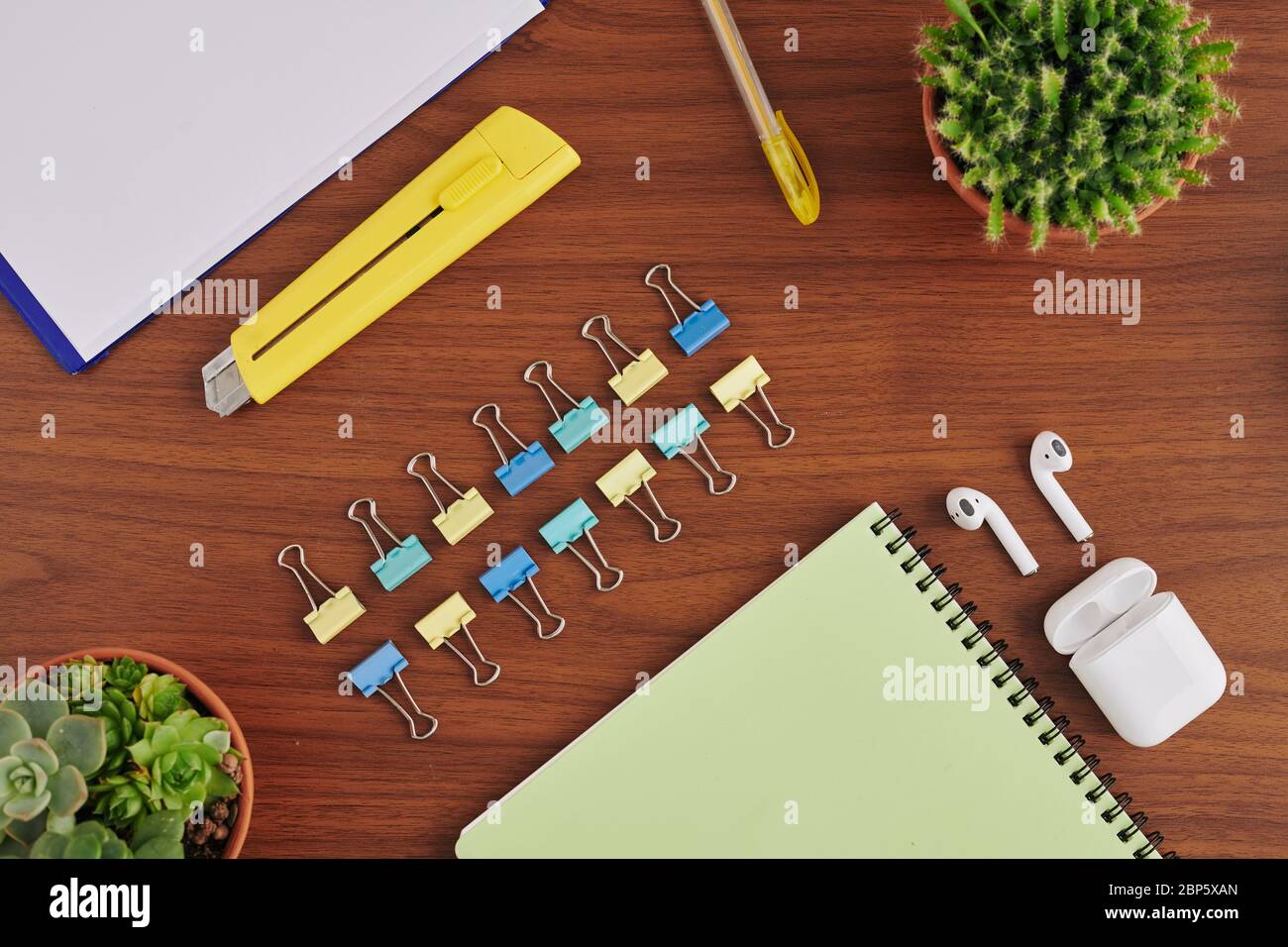Paper clips and paper knife on wooden table of university student, view ...