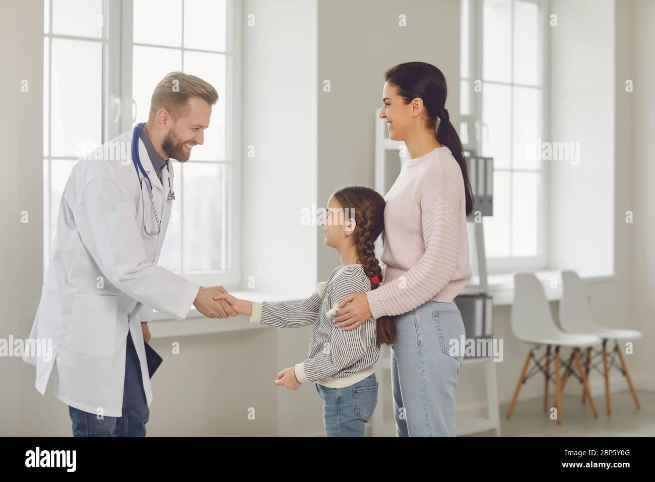 Happy family on a visit to the doctor in the office of a doctor Stock ...