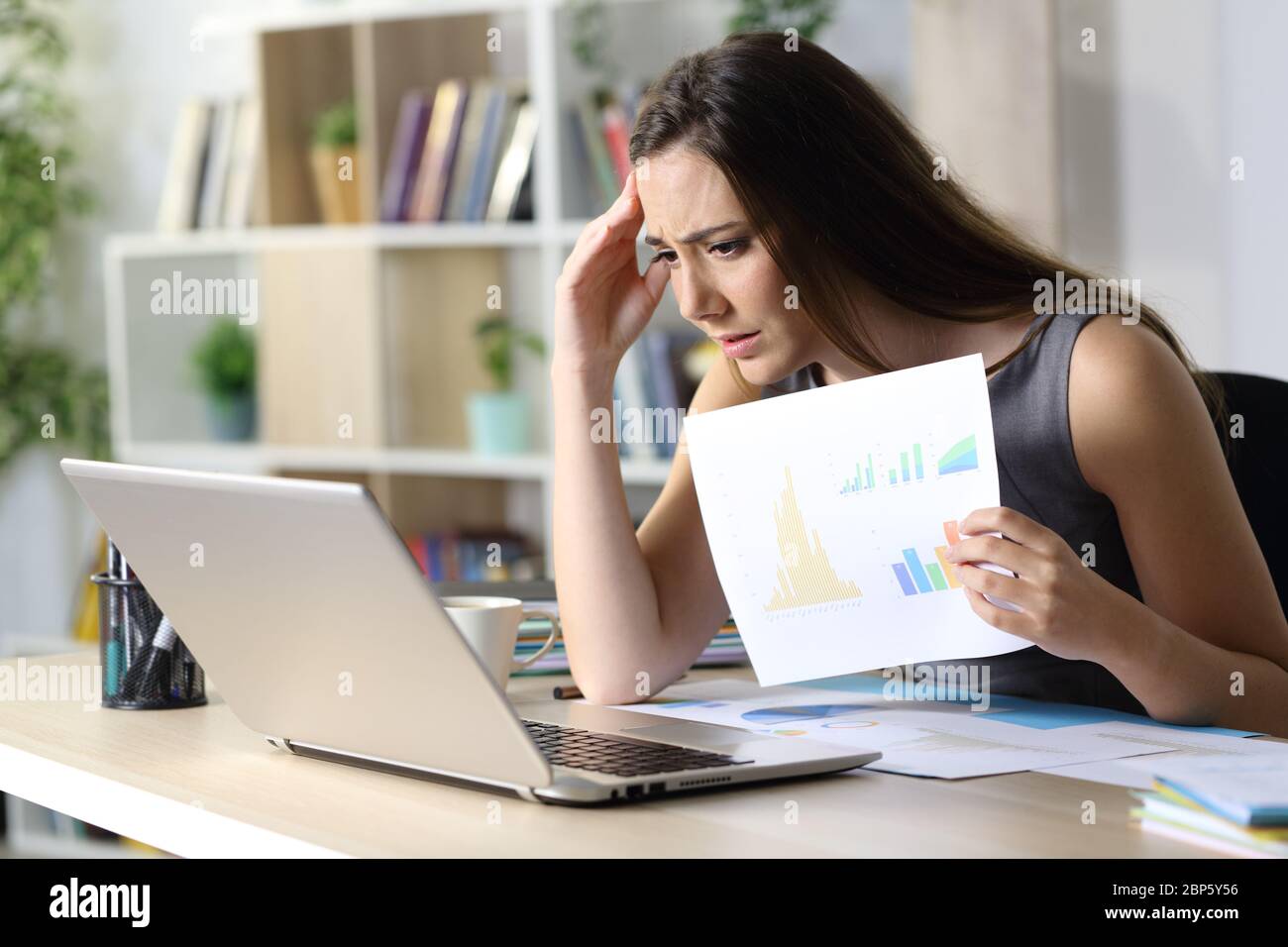 Sad entrepreneur woman showing bad report on videocall on laptop ...