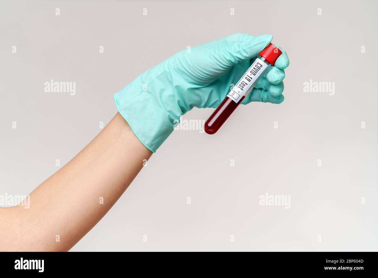 hand in latex glove holding blood in test tube close up Stock Photo - Alamy