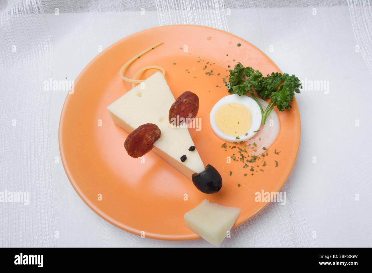 Cheese mouse with sausage and vegetal on the plate Stock Photo - Alamy