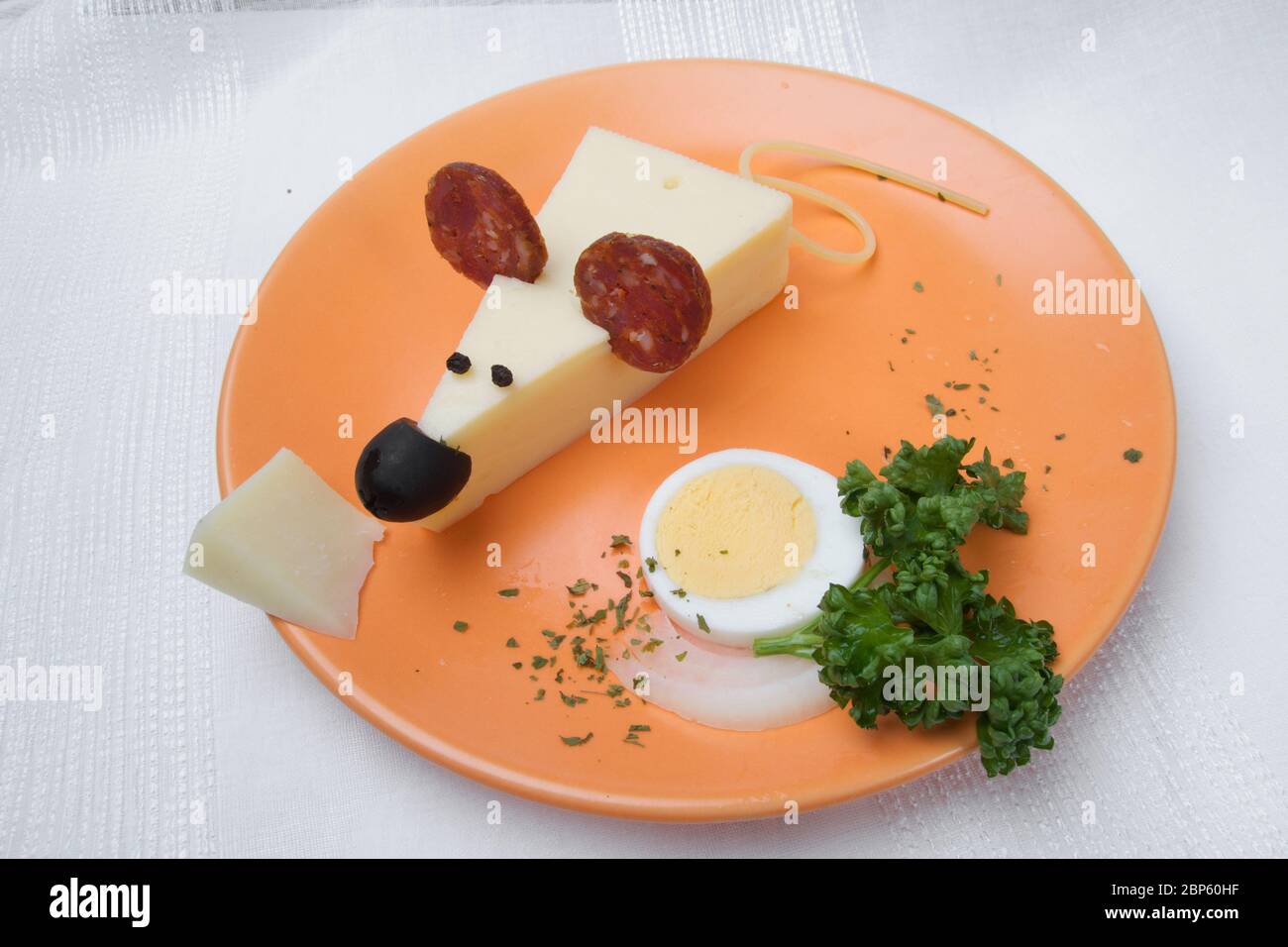 Cheese mouse with sausage and vegetal on the plate Stock Photo - Alamy