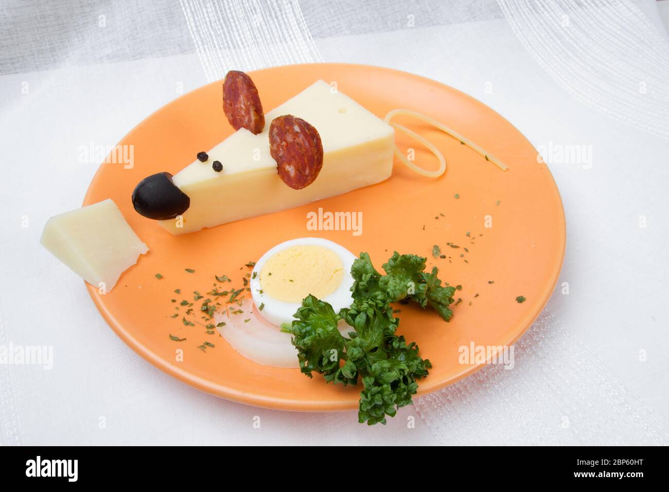 Cheese mouse with sausage and vegetal on the plate Stock Photo - Alamy