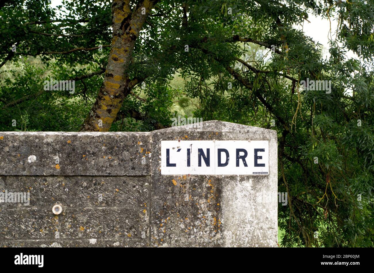 River name on a sign painted on a stone bridge over indicated River ...
