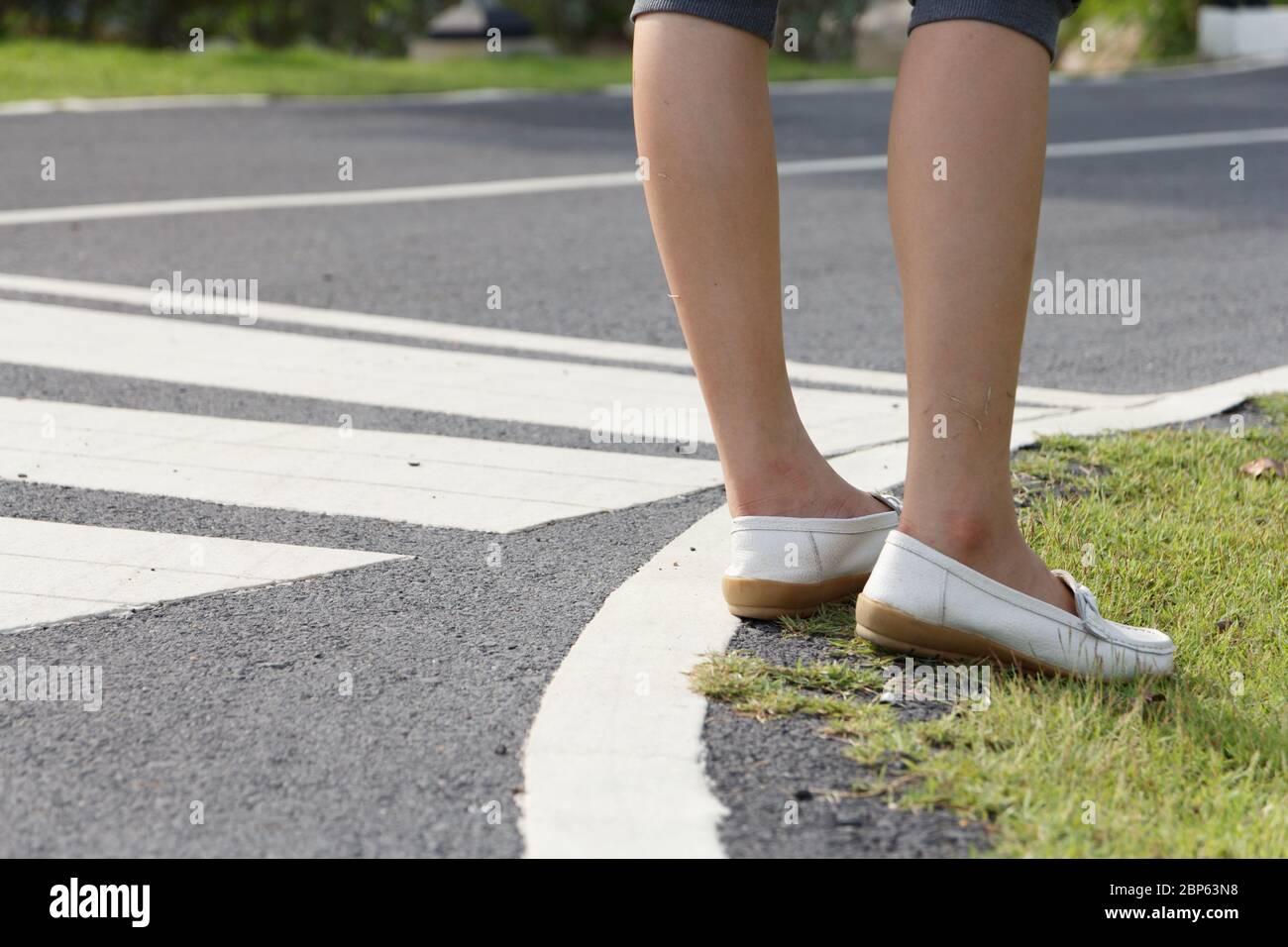 The woman sneaker shoes on the road Stock Photo - Alamy