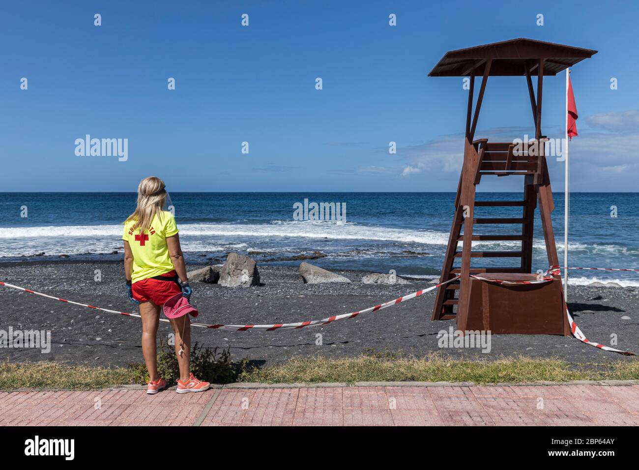 Lifeguard on duty next to lookout tower on Playa Enramada beach during ...
