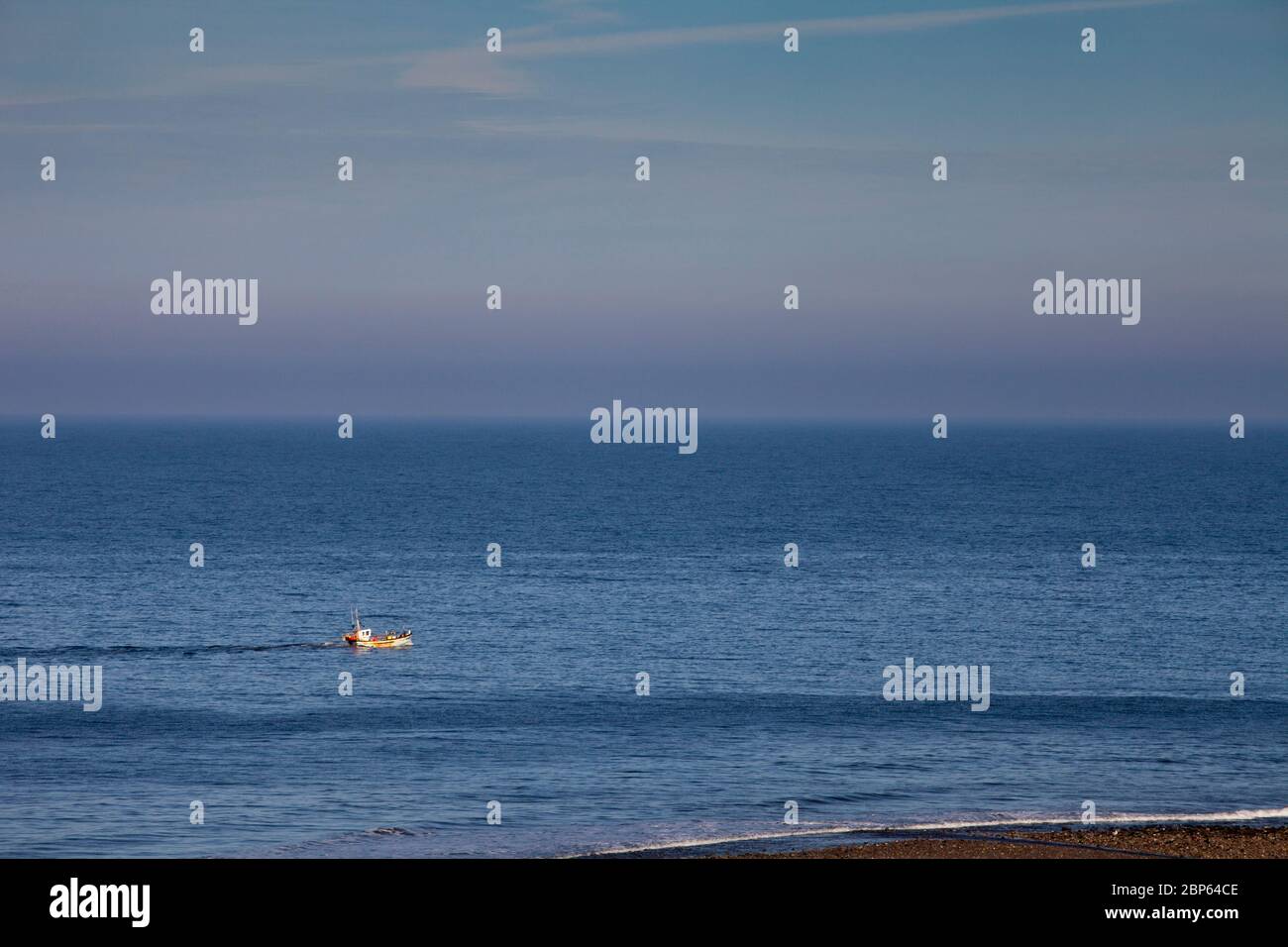 Small fishing boat off the Cumbrian coast in the Irish sea passing ...