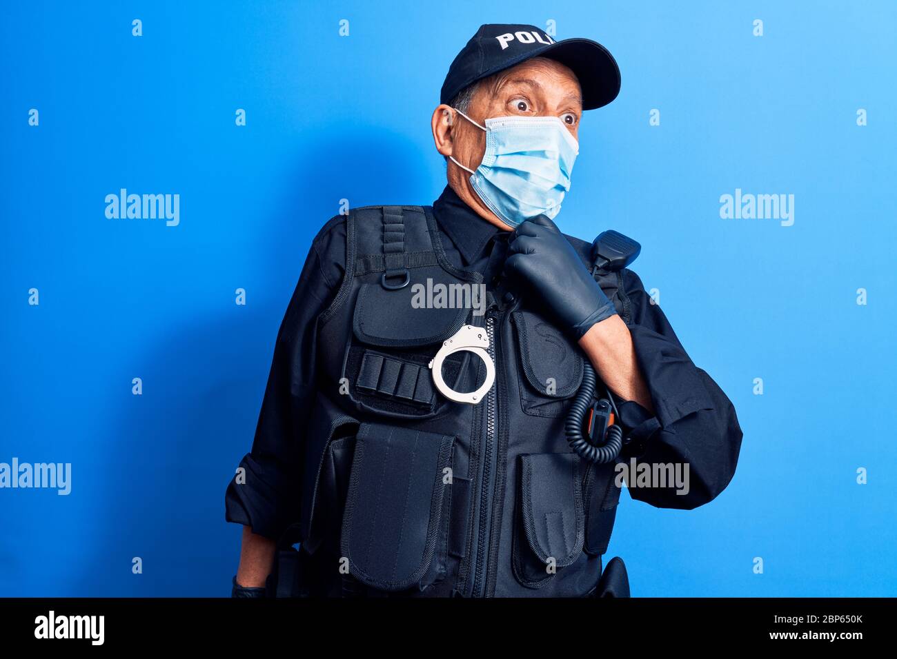 Senior police man wearing surgical mask looking stressed and nervous ...