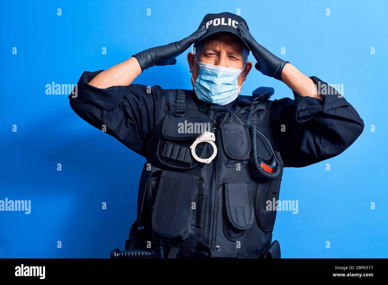 Senior police man wearing surgical mask suffering from headache ...
