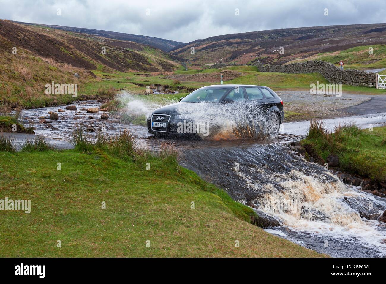 Car passes through the ford at Fore Gill Gate, Reeth Moor, North ...
