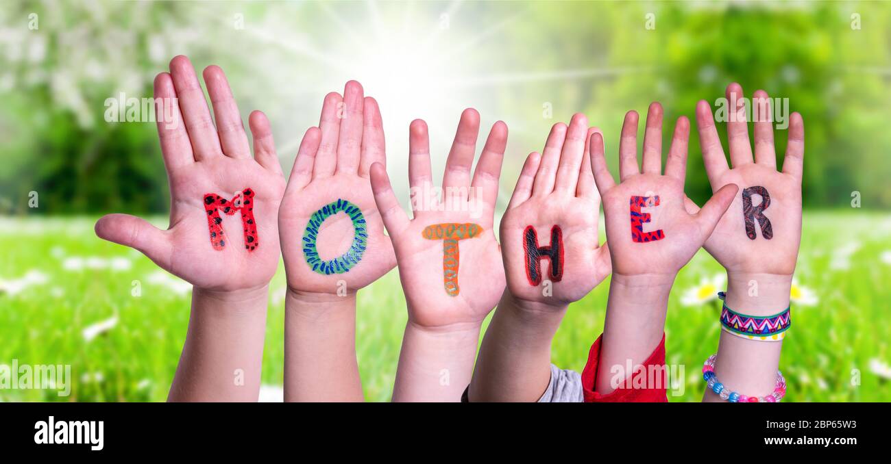 Children Hands Building Word Mother, Grass Meadow Stock Photo - Alamy