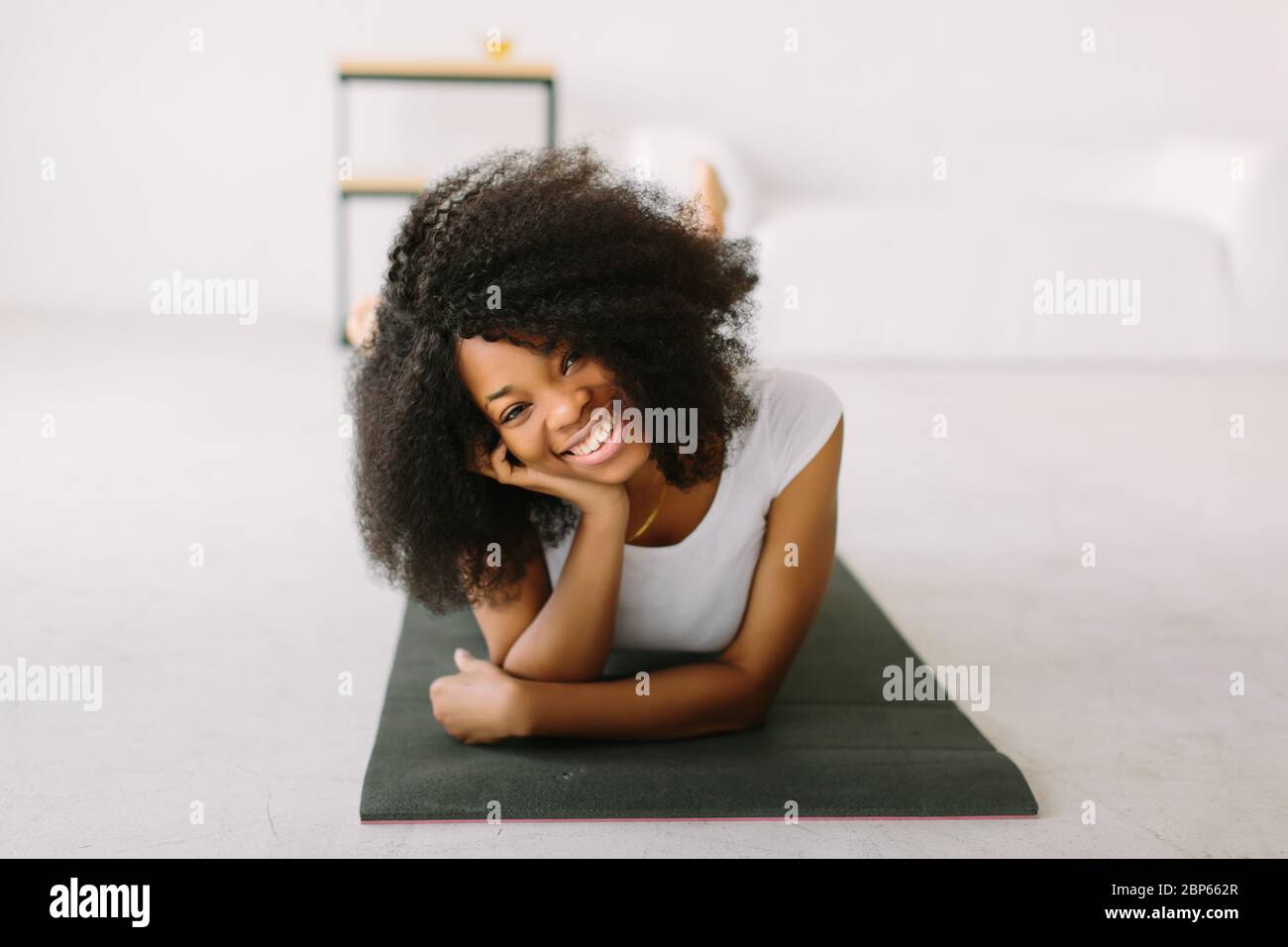 An African American young woman doing physical exercises in a mat Stock ...