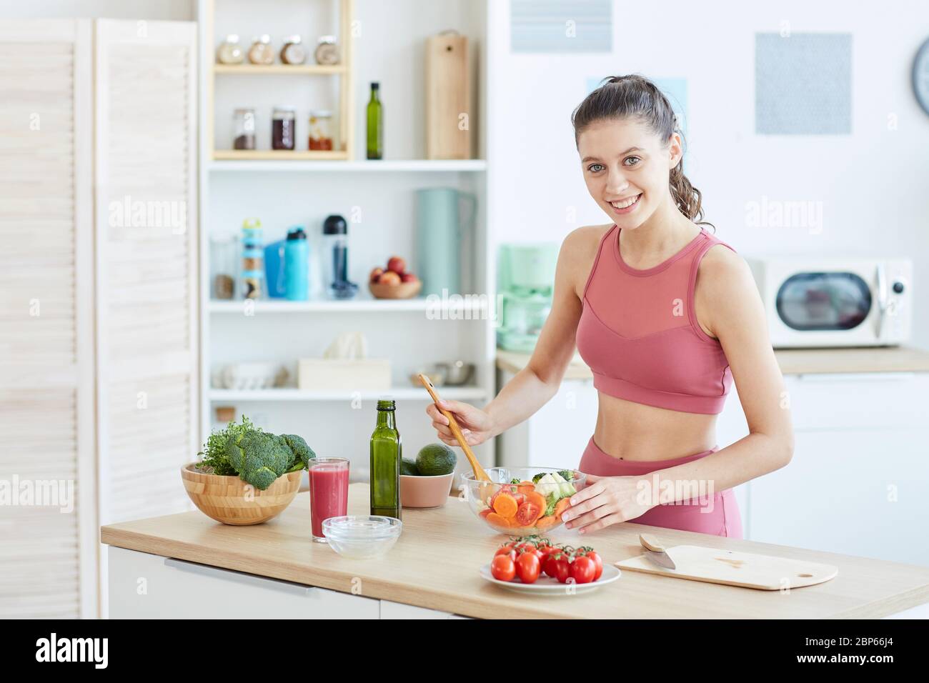 Waist up portrait of fit young woman cooking fitness food in kitchen ...