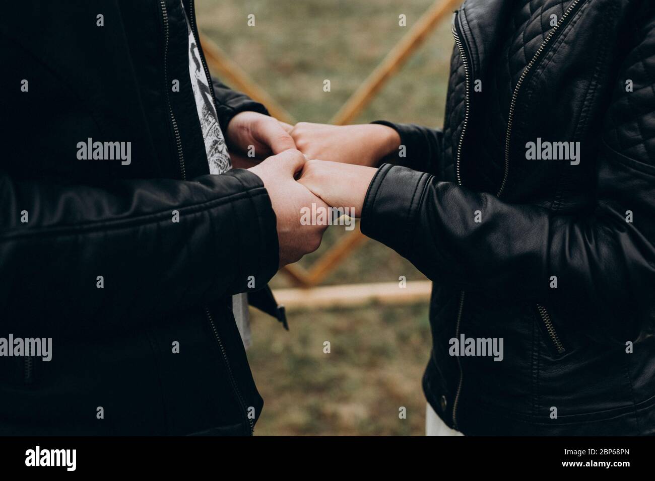 young white man gently touches the hand of his bride Stock Photo - Alamy