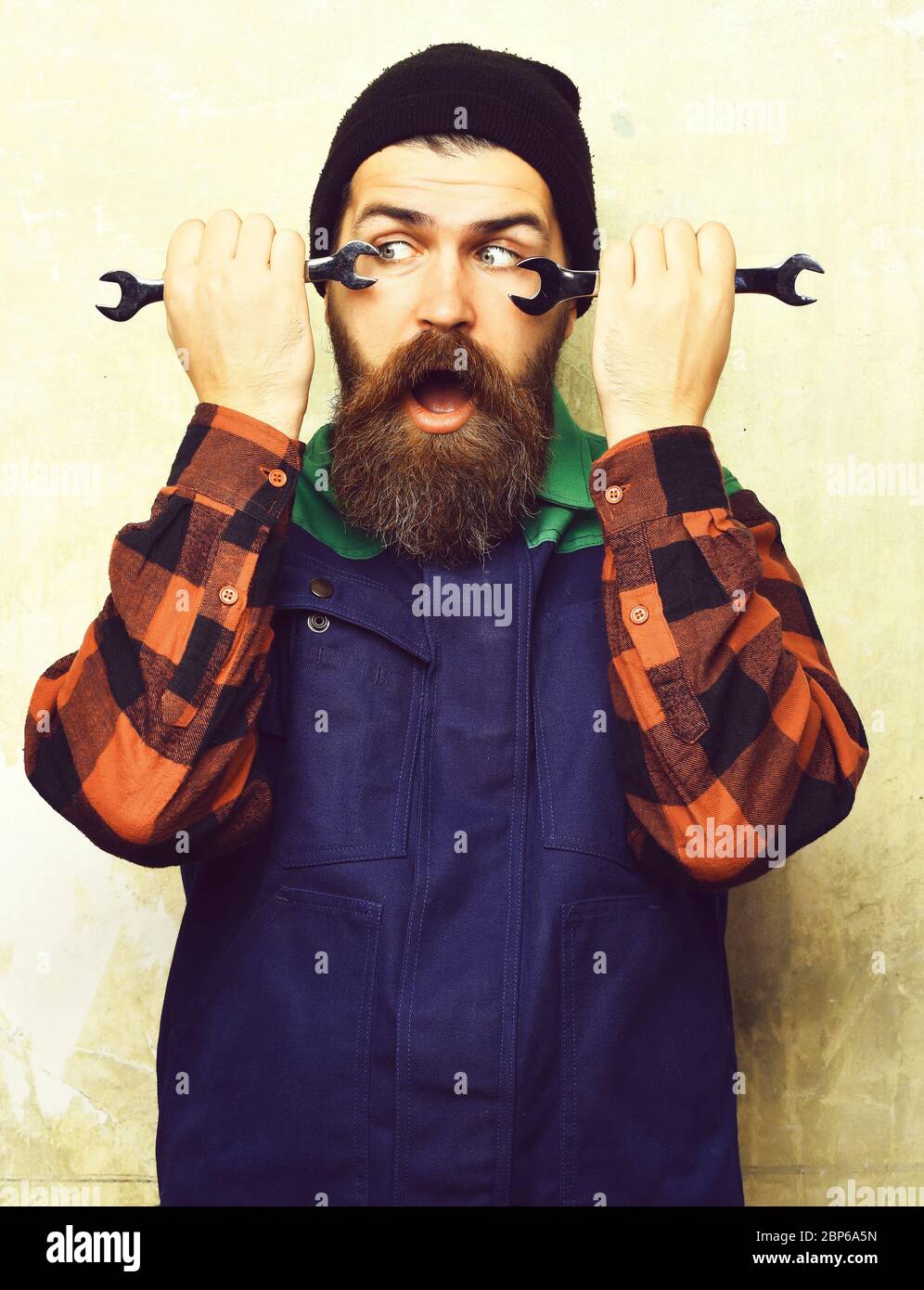 Bearded man, long beard. Brutal caucasian mechanic, surprised unshaven ...