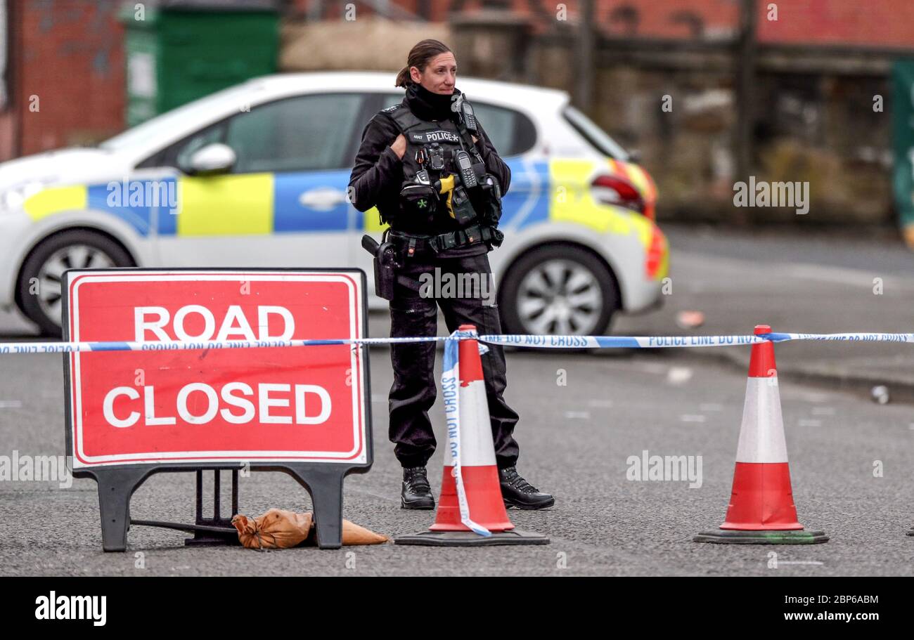 An armed police officer at the scene on King Street, Blackburn ...