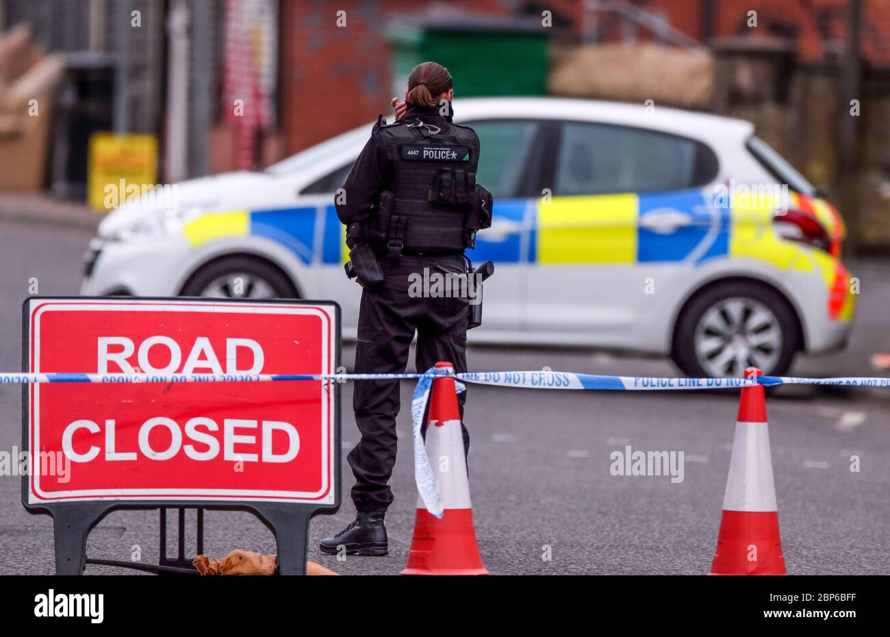 An armed police officer at the scene on King Street, Blackburn ...