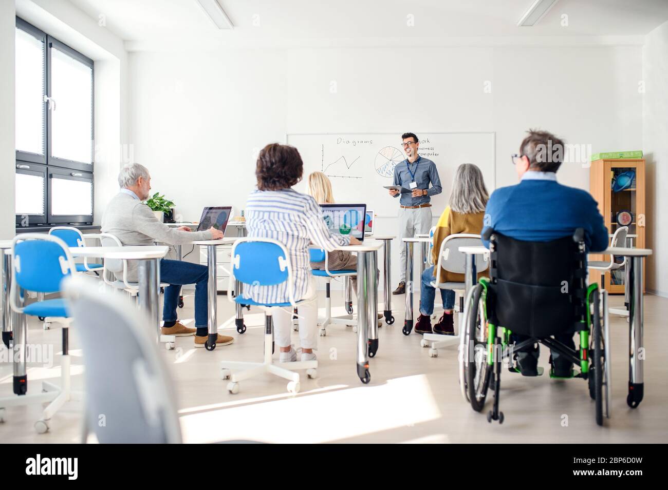 Group of senior people attending computer and technology education ...