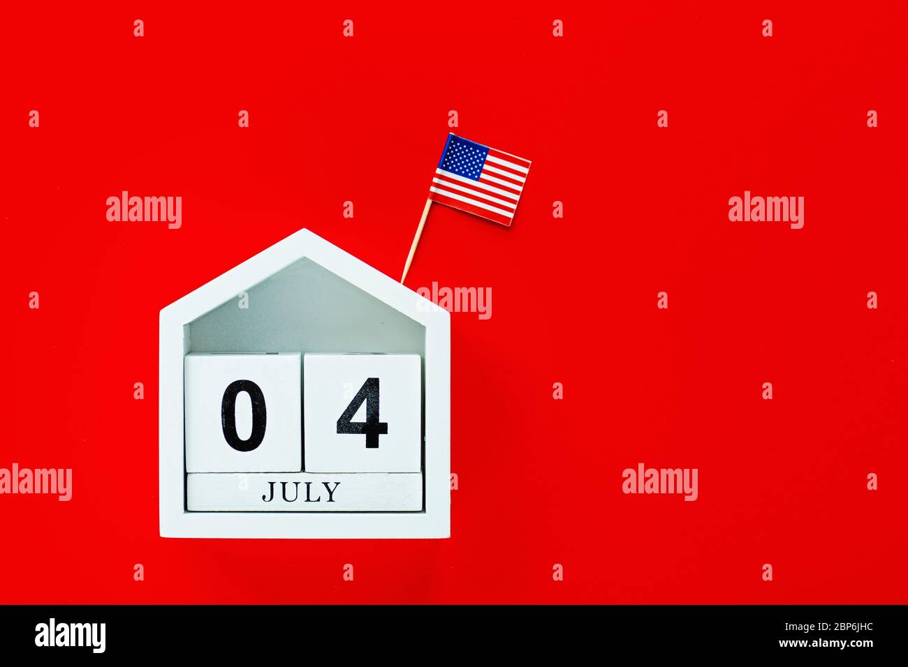 July 4th. Mockup of july 4 wooden color calendar on red background ...