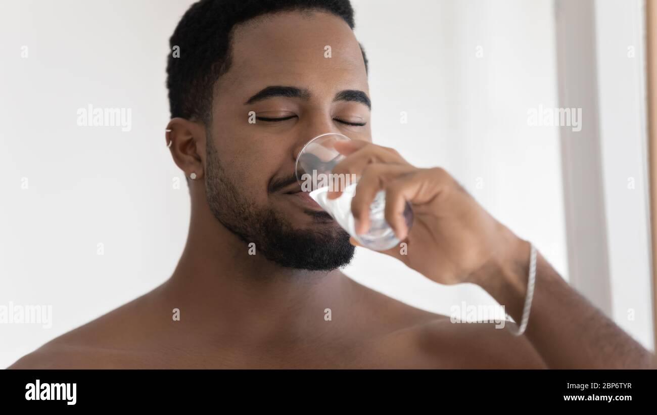African man drinking from water hi-res stock photography and images - Alamy