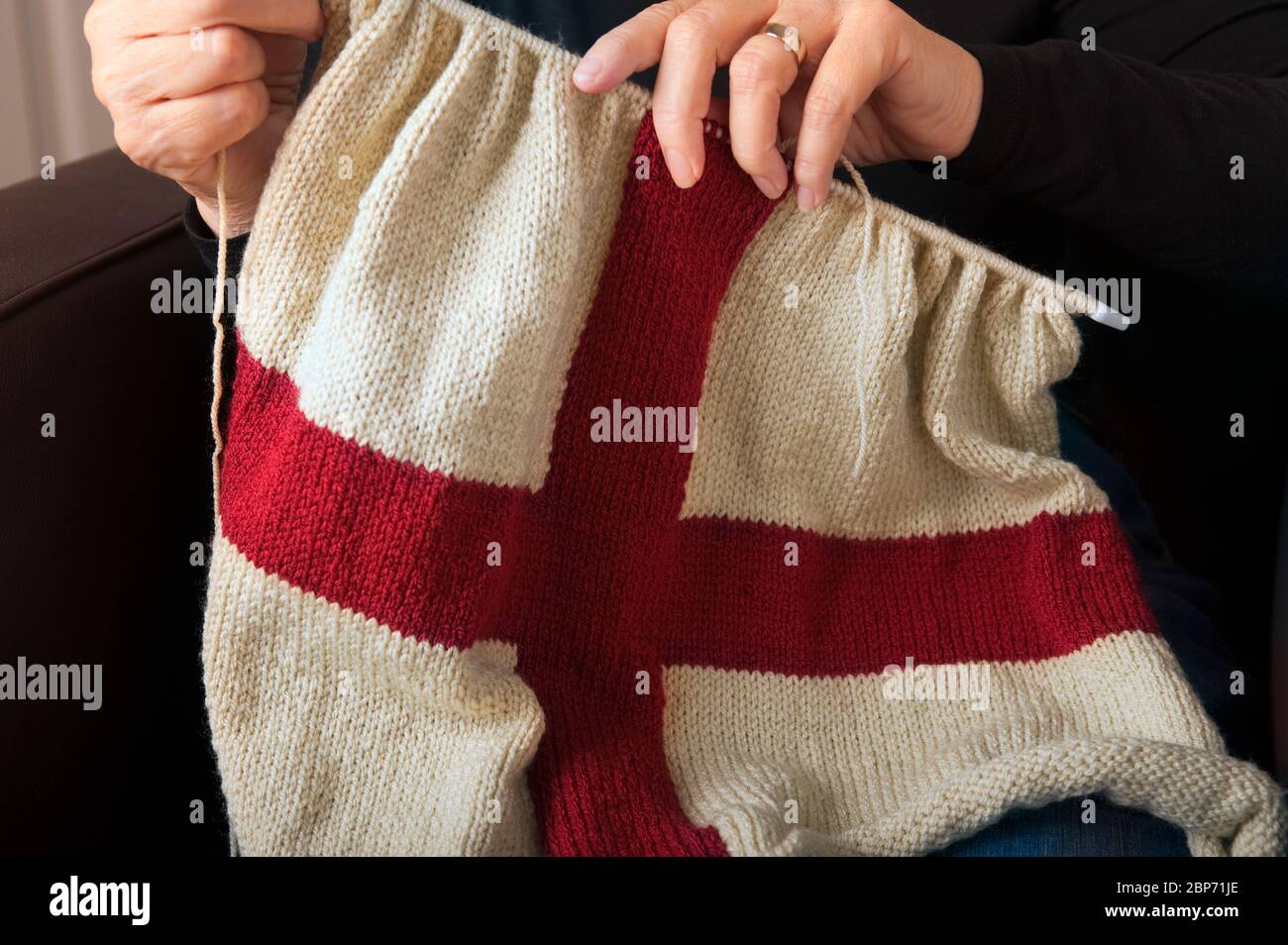 Woman hand knitting an English St Georges Cross flag Stock Photo - Alamy