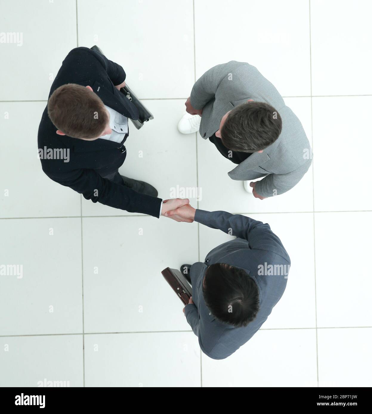 top view. business people confirm the transaction with a handshake ...