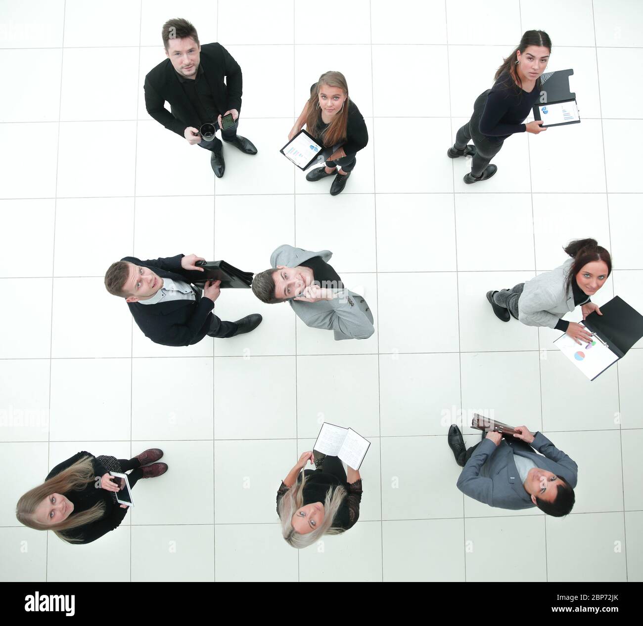 top view. group of serious diverse business people looking at the ...