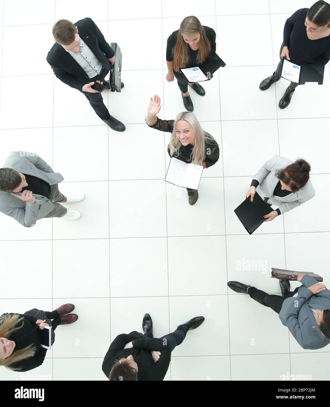 top view. group of serious diverse business people looking at the ...