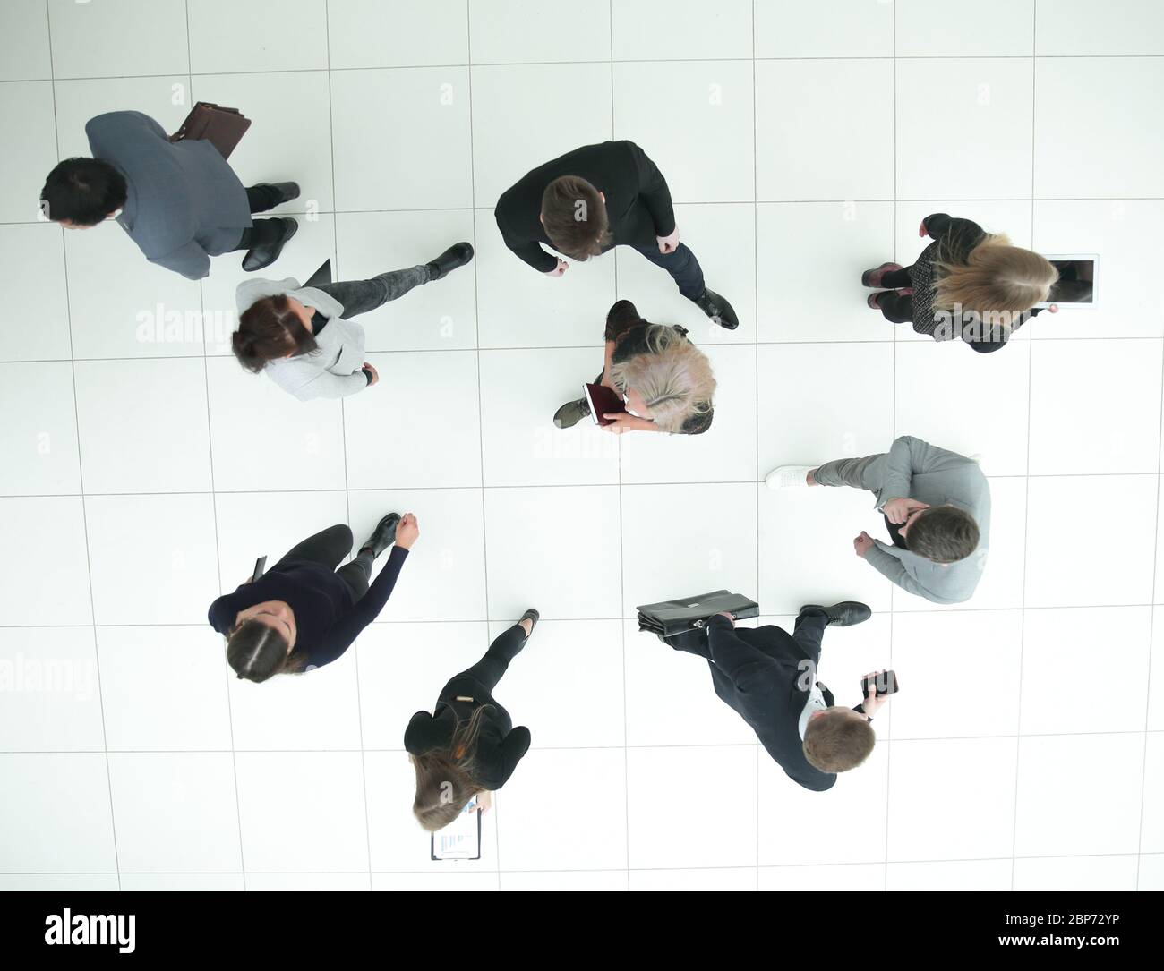 top view. group of serious diverse business people looking at the ...