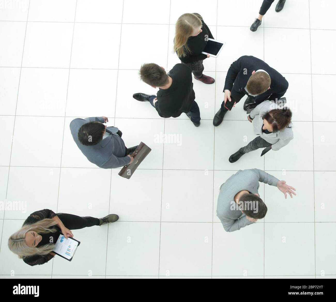 top view. group of serious diverse business people looking at the ...