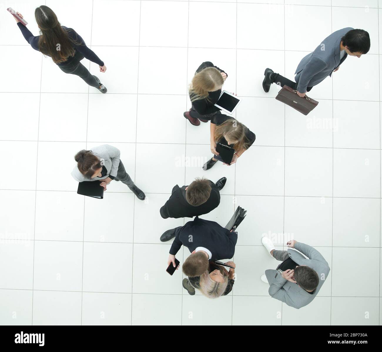 top view. group of serious diverse business people looking at the ...