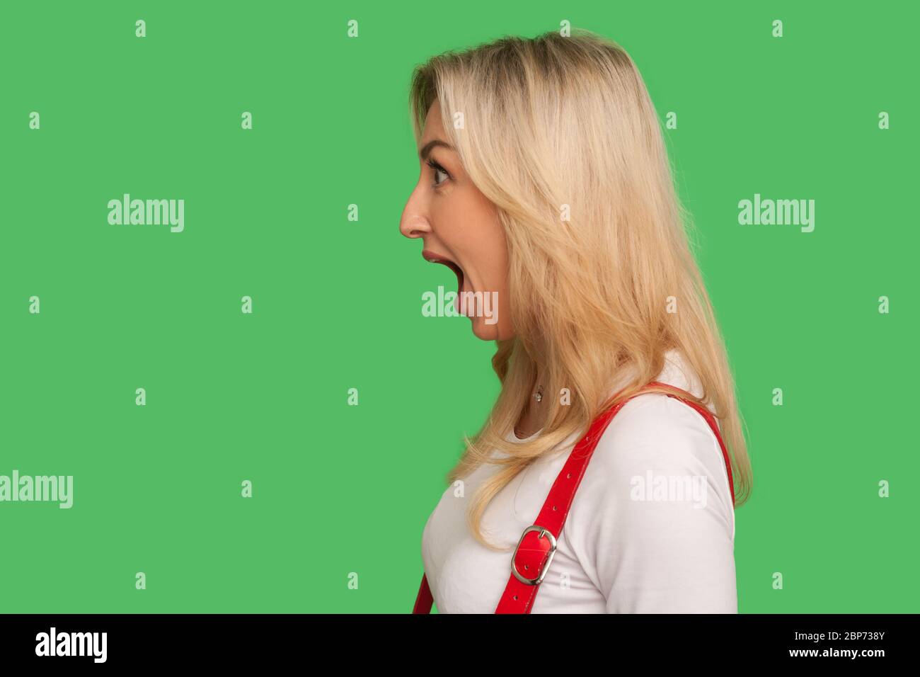 Wow, unbelievable! Side view of astonished adult blond woman standing ...