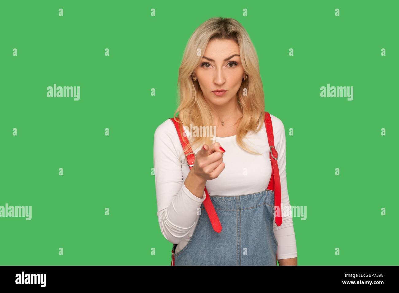 Hey, I'm warning you! Portrait of displeased angry adult blond woman in ...