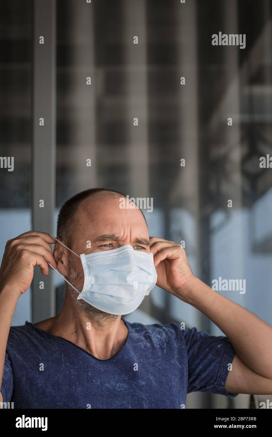 Man wearing facial disposable mask to avoid viral infection. Virus ...