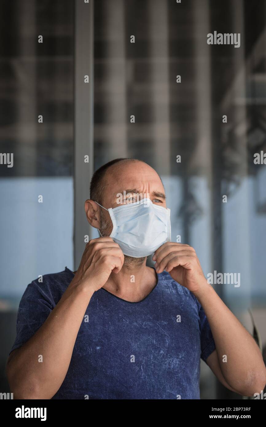Man wearing facial disposable mask to avoid viral infection. Virus ...