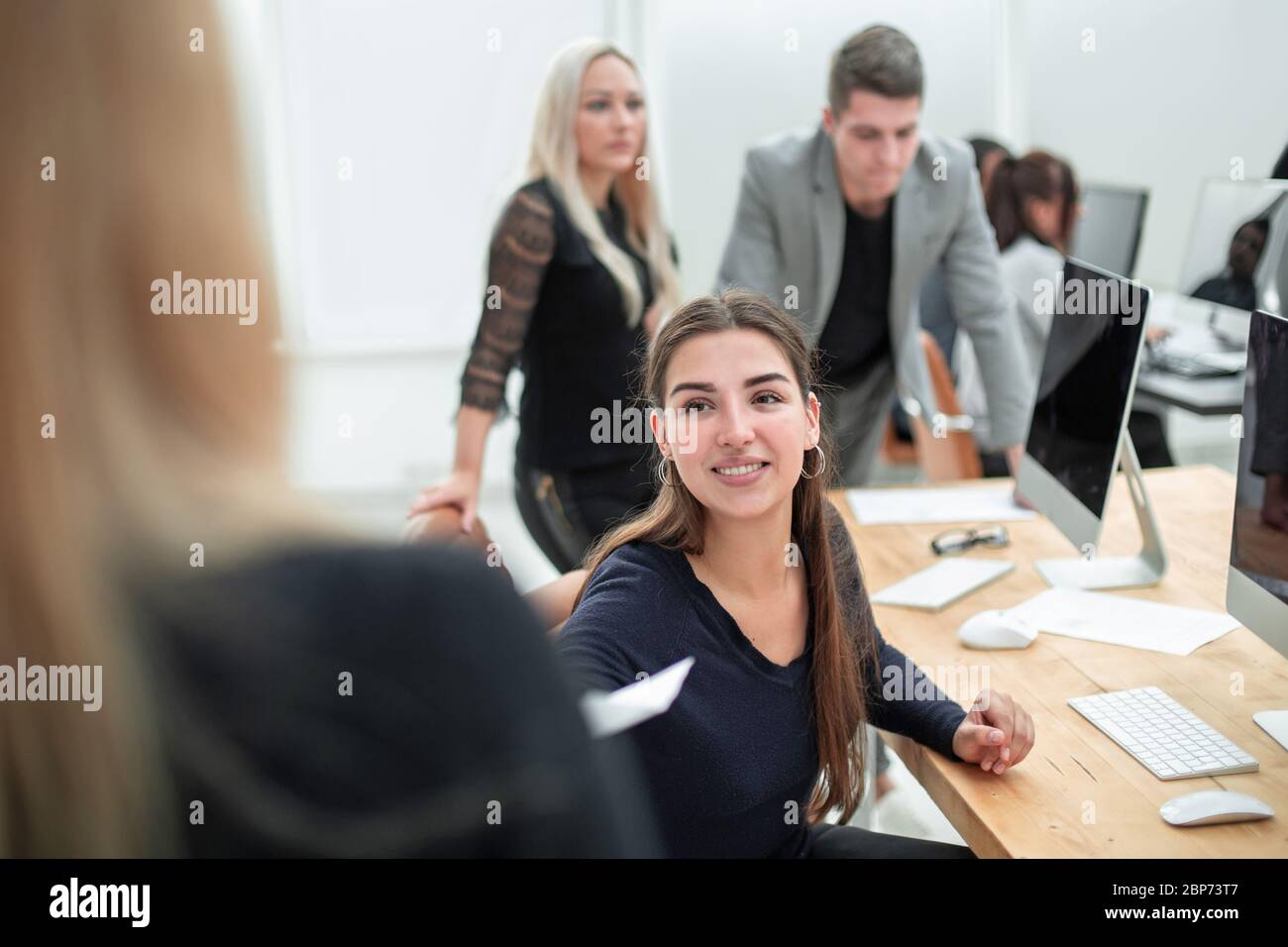 group of employees work on computers in the office Stock Photo - Alamy