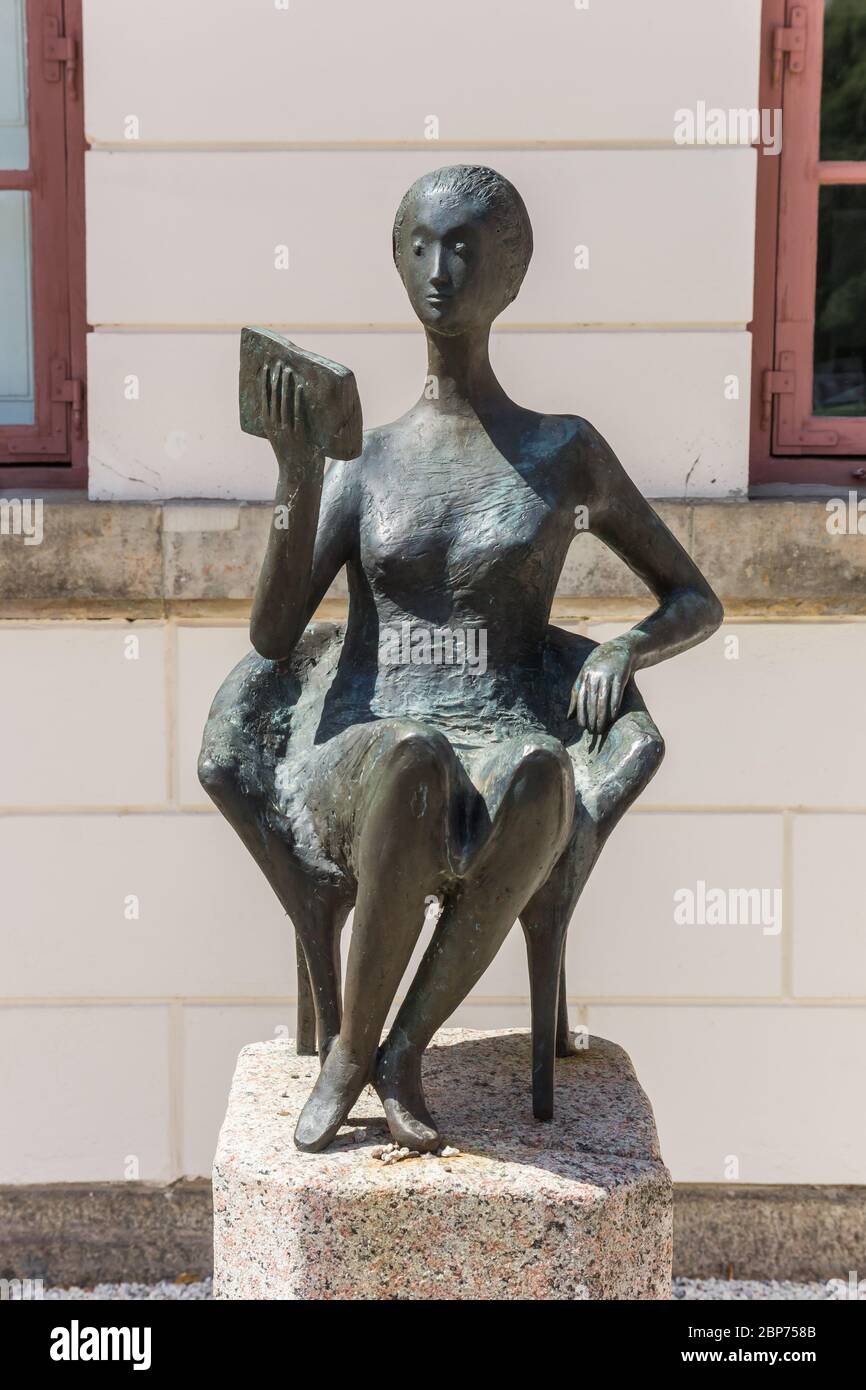 Sculpture of a woman reading in front of the library in Eutin, Germany ...