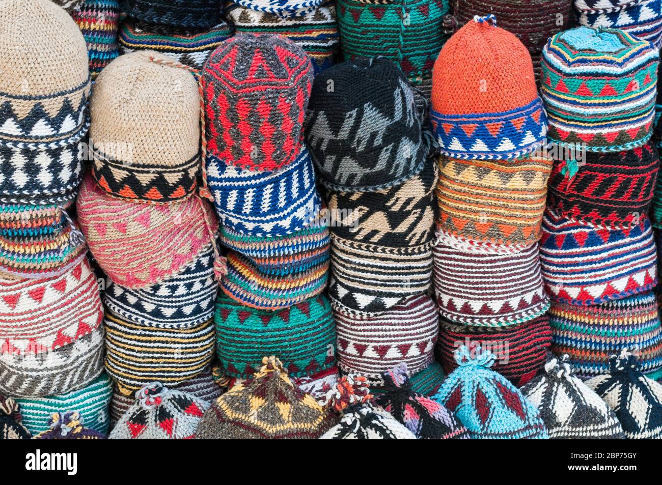 Various stacked knitted caps Stock Photo - Alamy