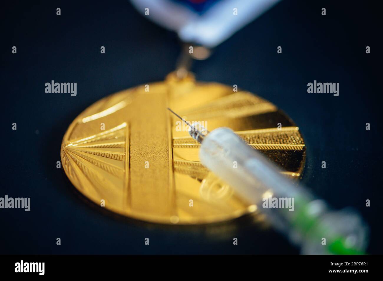 Gold medal and syringe. Doping and drugs in sport, concept photo. Black ...